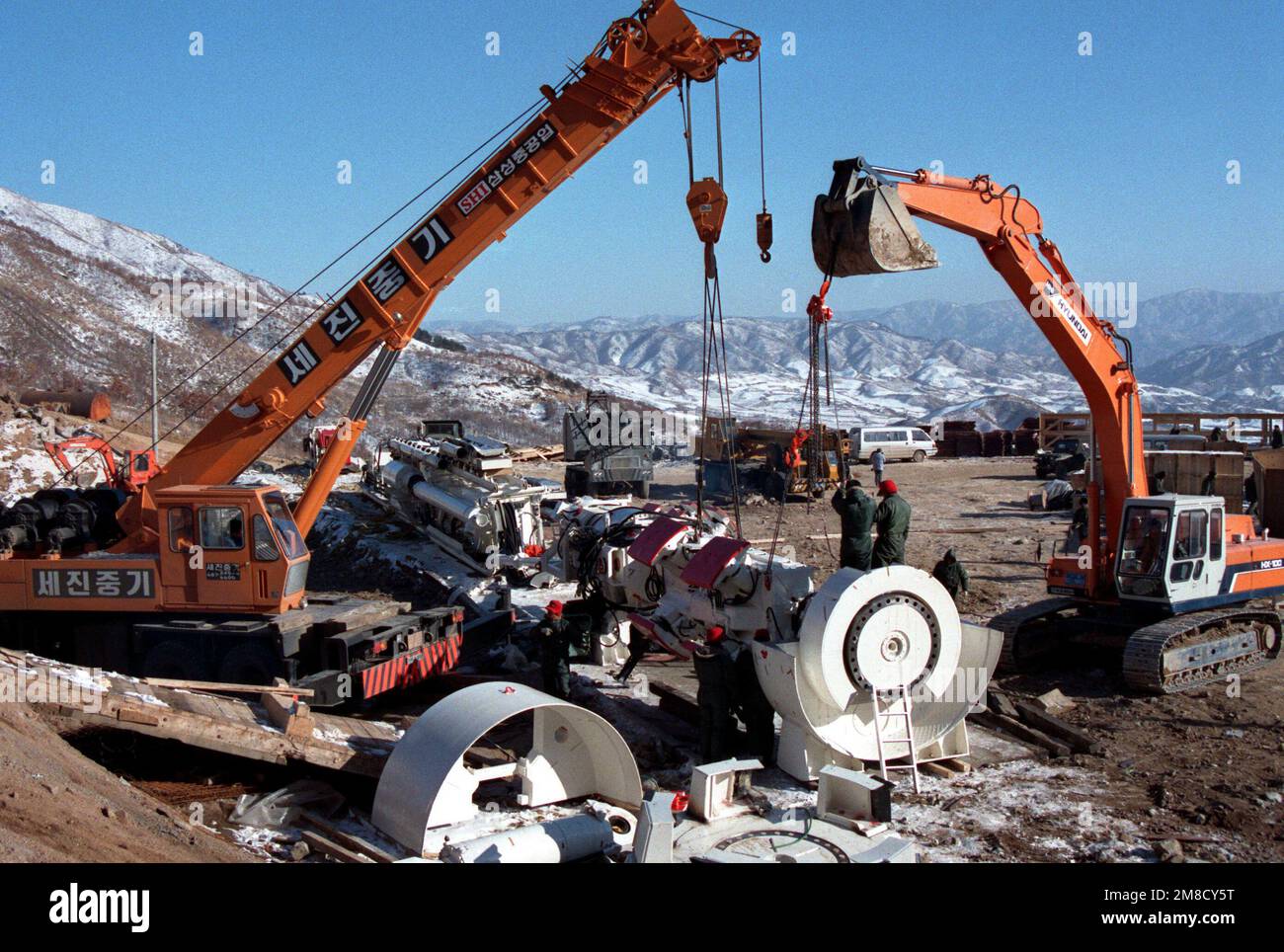 Engineers assemble tunnel boring equipment near Kach'il-Bong Peak, the ...