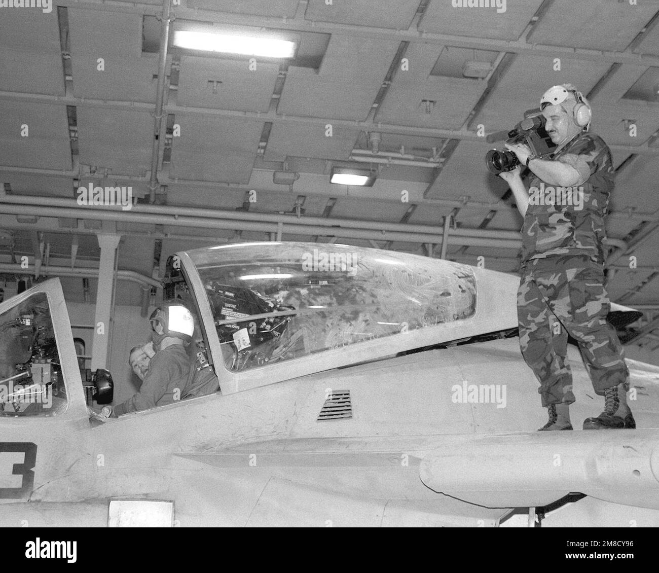 PH2 John Carnes stands on the wing of an Attack Squadron 75 (VA-75) A ...