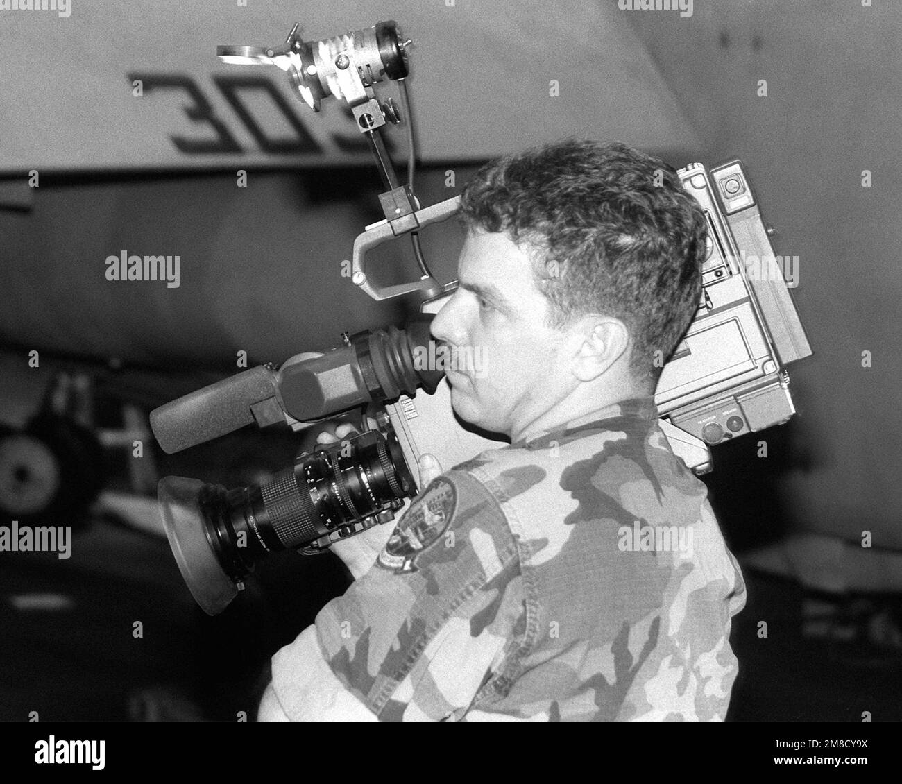PH1 James Slaughenhaupt of Fleet Imaging Command shoulders his video ...