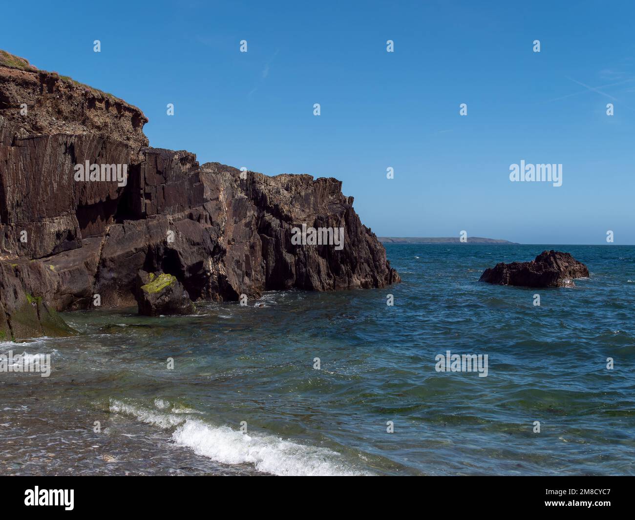 A rock among the blue sea waters. Seaside landscape, rocky mountain ...