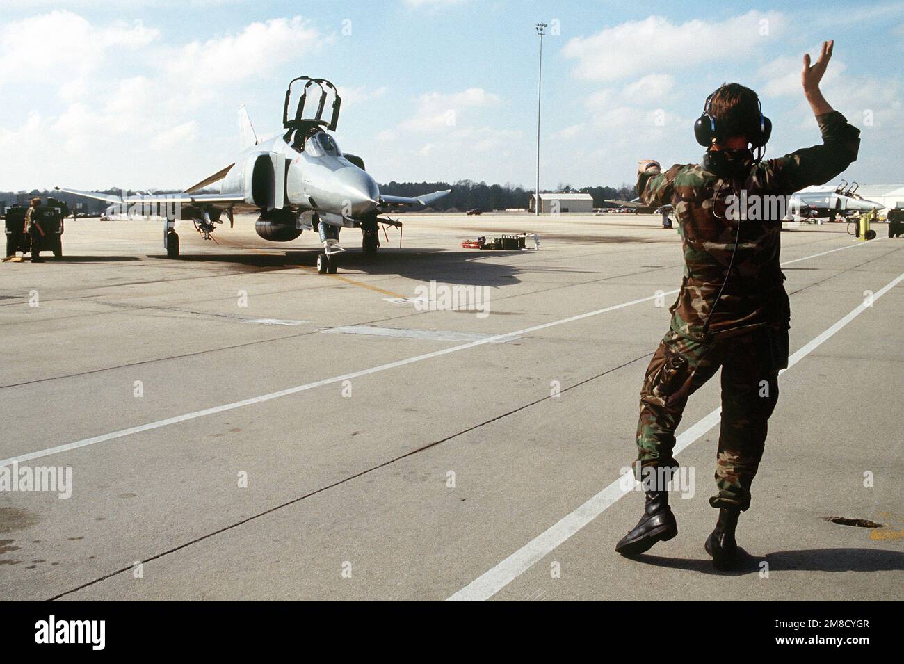 SRA Roy Kirkham, 335th Aircraft Maintenance Unit, signals the pilot of ...