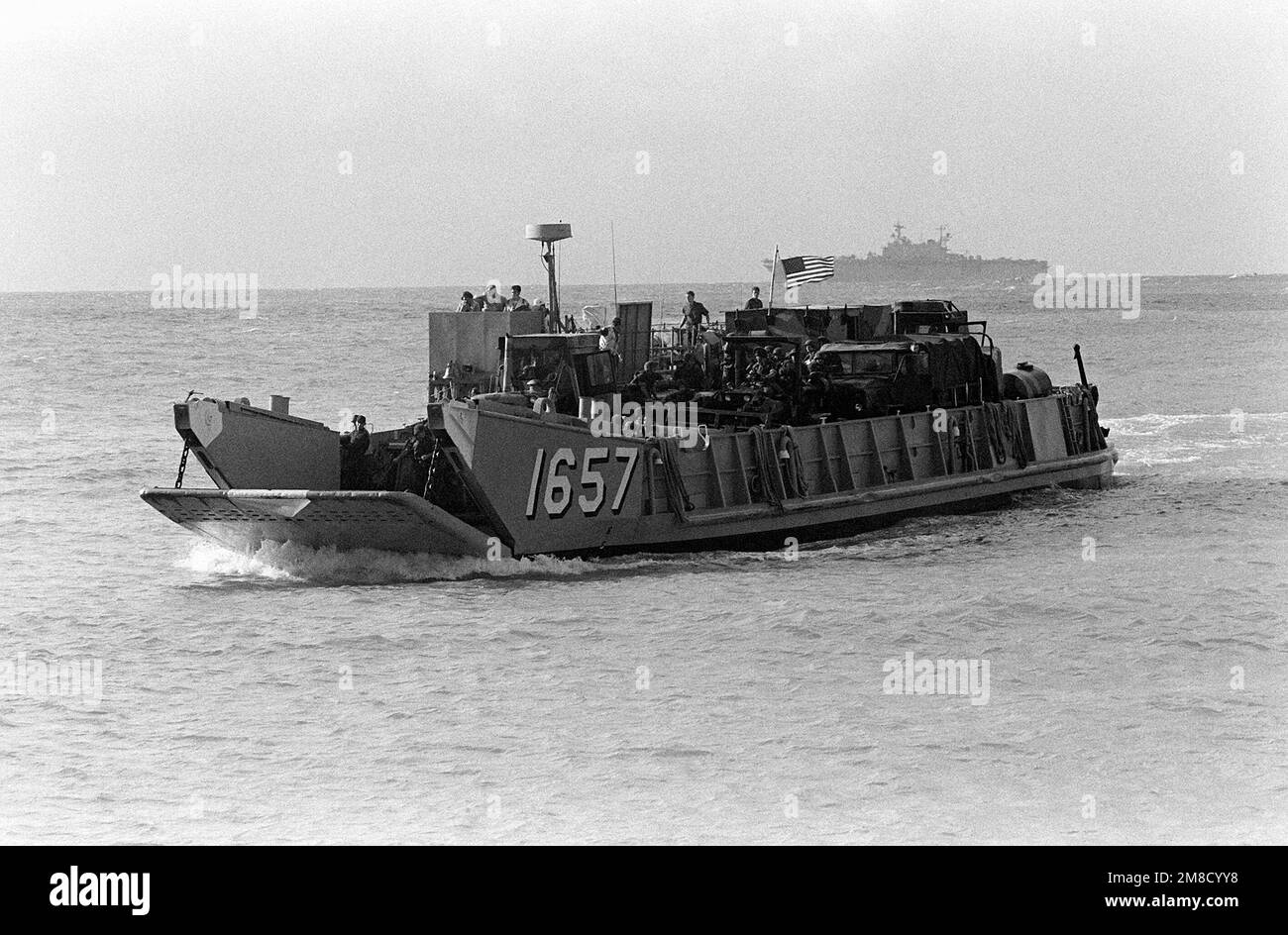 The utility landing craft LCU-1657 begins to lower its ramp as it ...