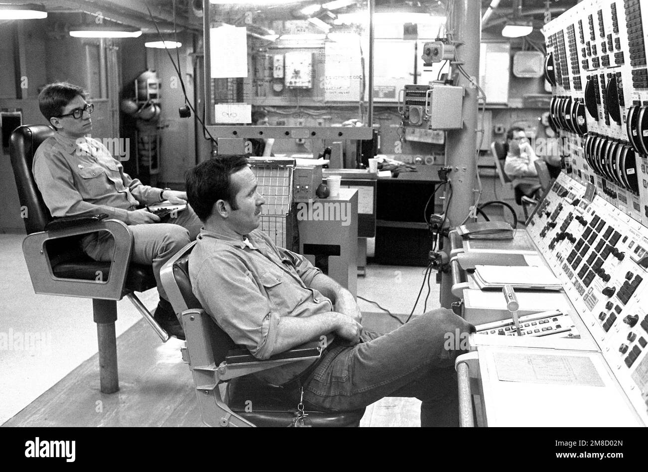 Crew members monitor the engine control panel in the central control ...