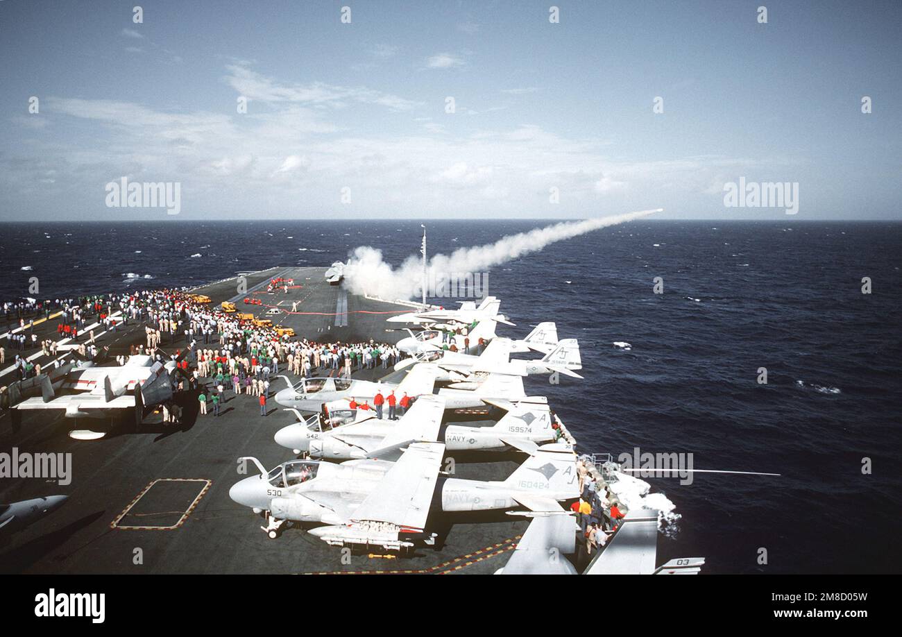 Crew members watch as a trainer missile is launched from a Mark 29 NATO ...