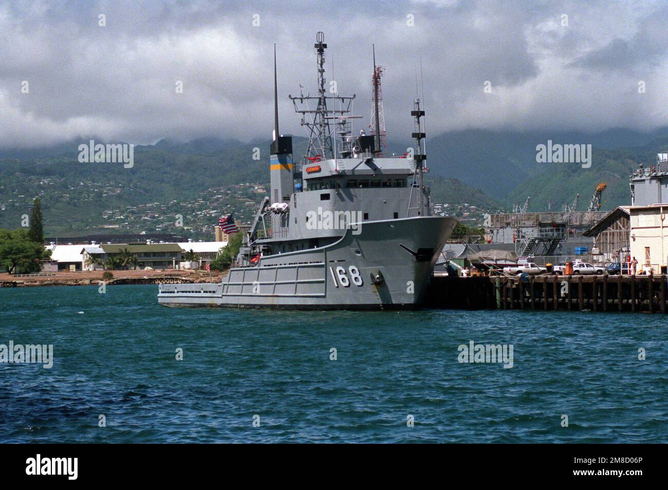 The fleet tug USNS CATAWBA (T-ATF-168) stands moored to a pier. Base ...