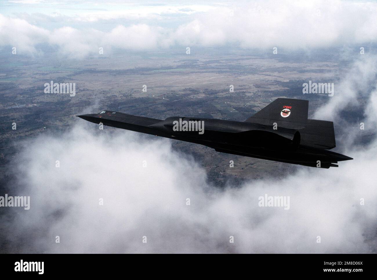 An air-to-air left side view of an SR-71 aircraft. Country: Unknown ...