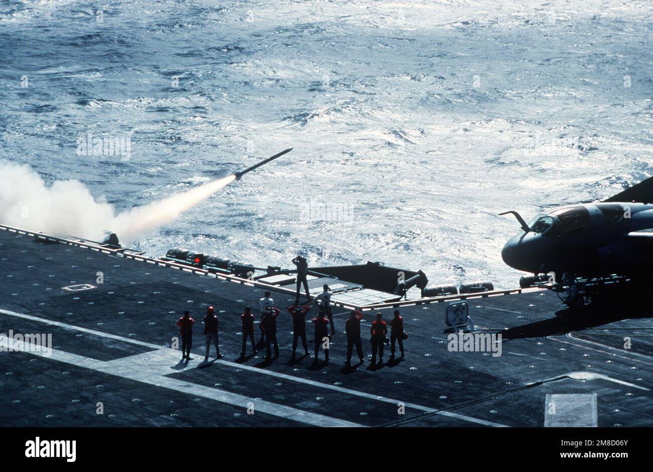 Crew members watch as a trainer missile is launched from a Mark 29 NATO ...