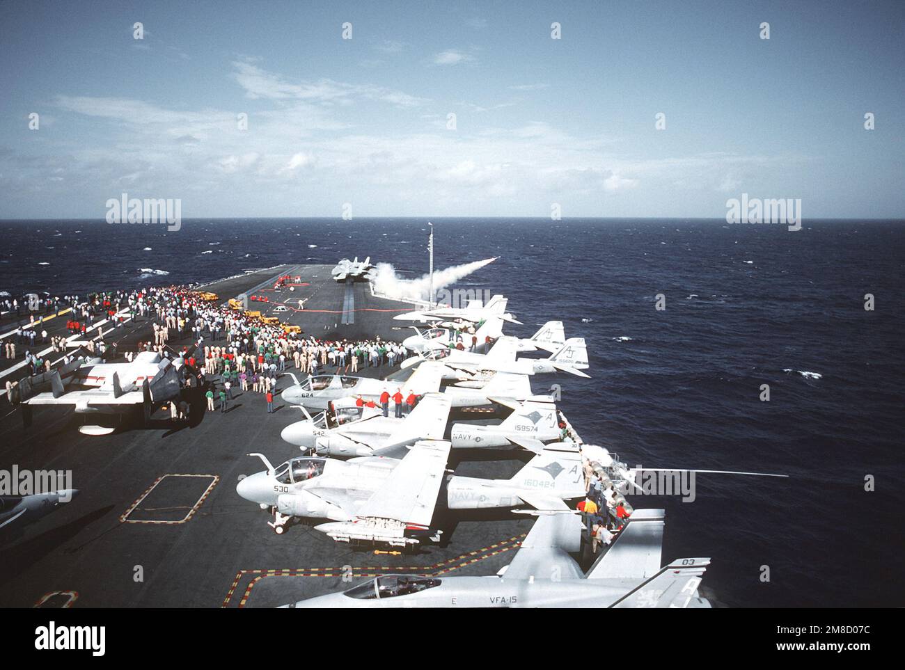 Crew members watch as a trainer missile is launched from a Mark 29 NATO ...