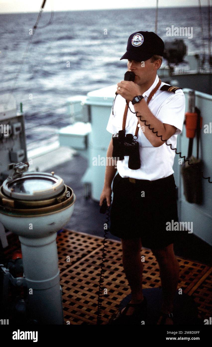 An officer stands watch on the open-air bridge aboard the Canadian ...