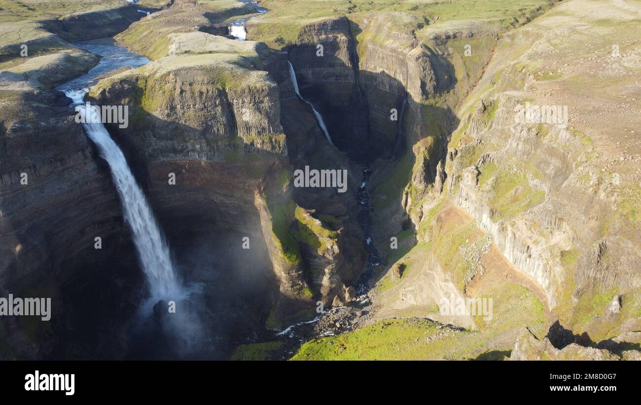 A drone shot over Haifoss Waterfall in Iceland river Fossa on a sunny ...