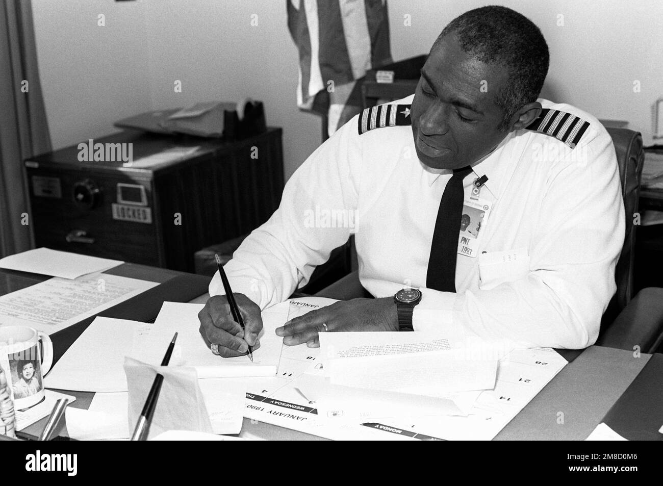 CAPT Mack C. Gaston tends to paperwork in his office at the Pentagon ...