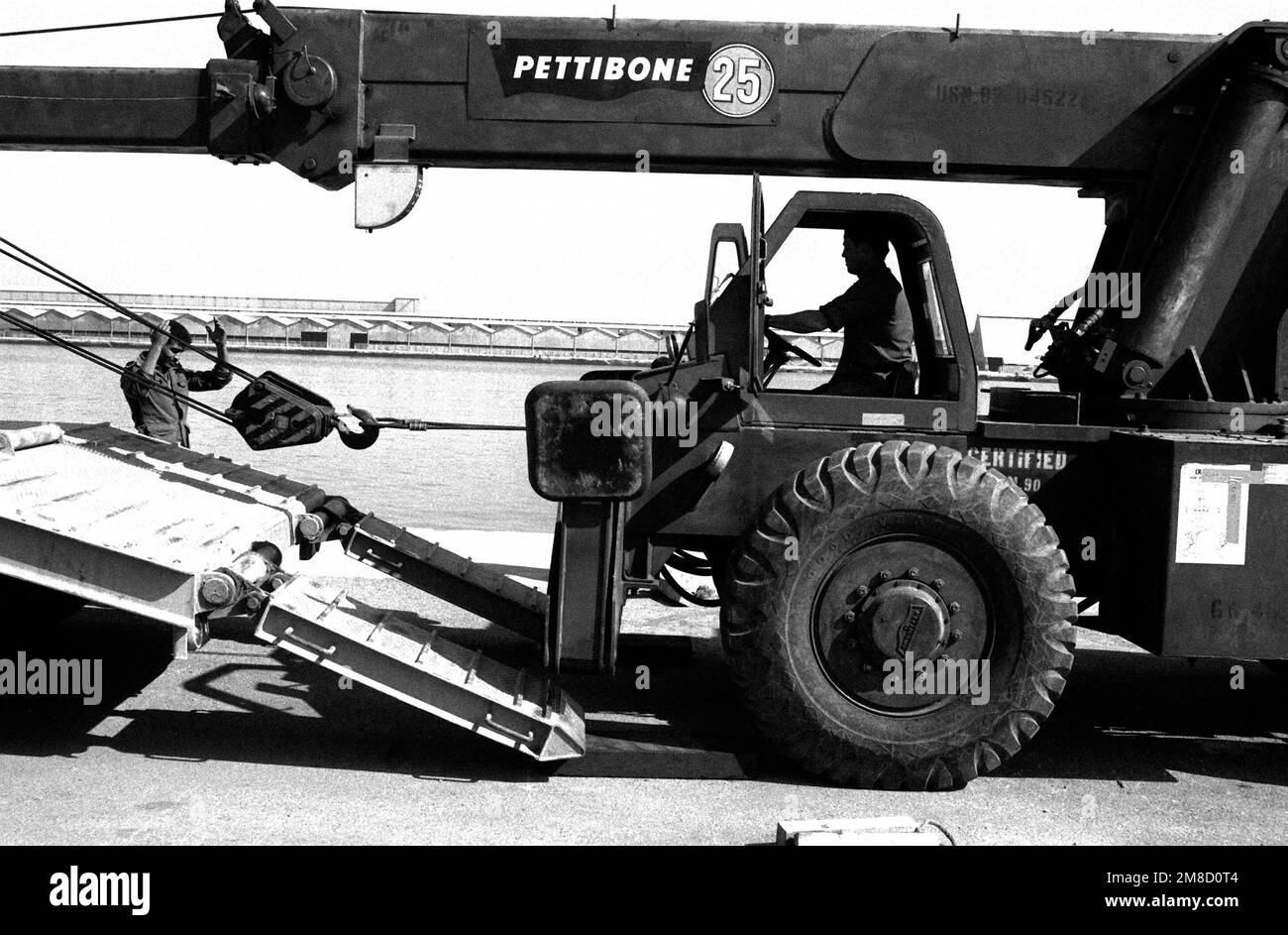 A crane is unloaded from the dock landing ship USS PORTLAND (LSD 37 ...