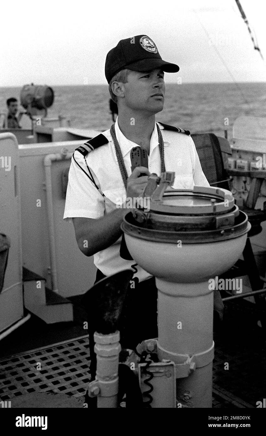 An officer stands watch on the open-air bridge aboard the Canadian ...