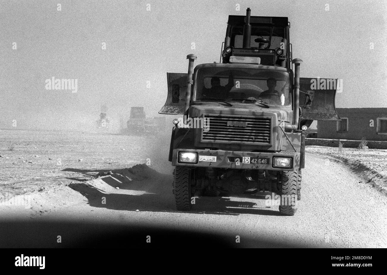 A truck convoy heads out to a US Navy Seabee base camp during exercise ...