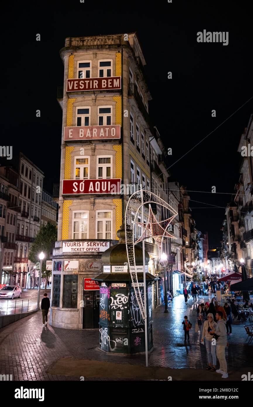A vertical night picture of streets ad buildings in Porto, Portugal ...