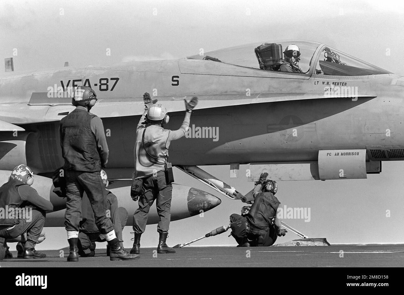 A Strike Fighter Squadron 87 (VFA-87) F/A-18A Hornet aircraft is hooked ...