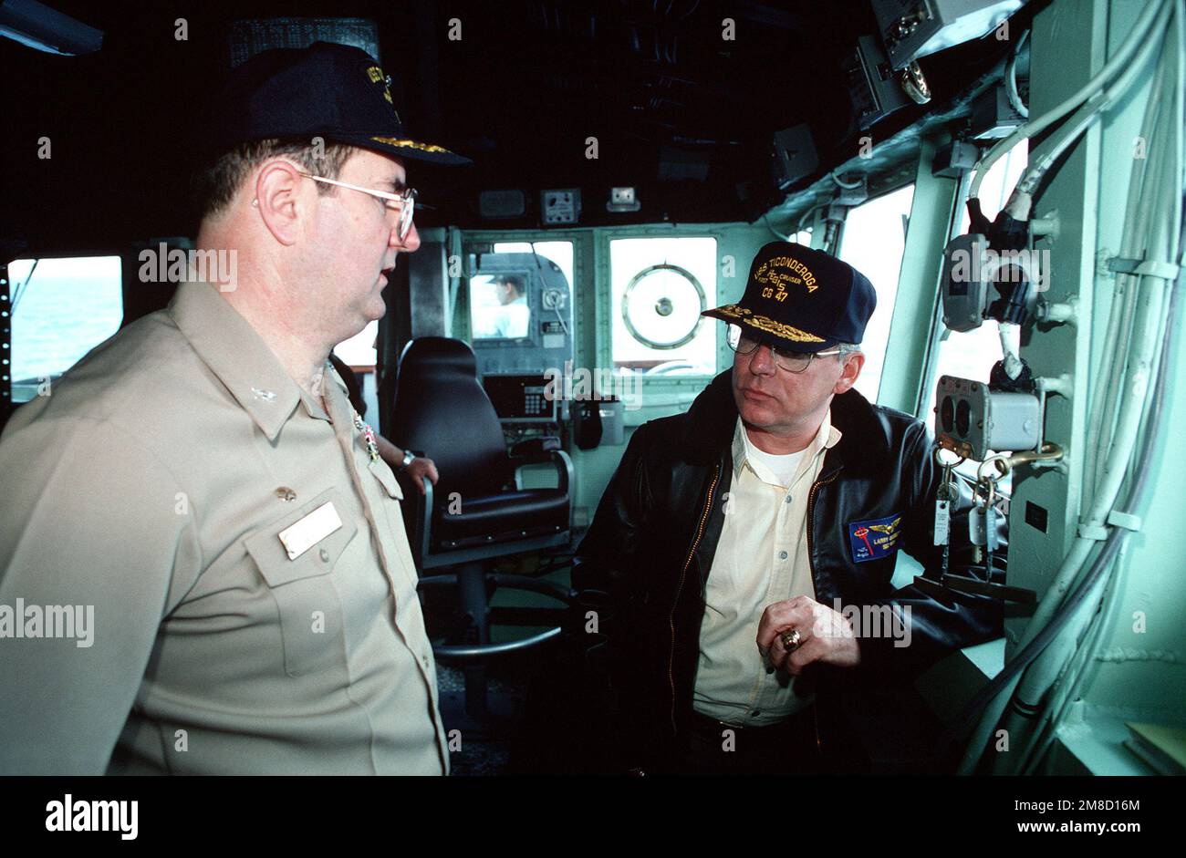 Secretary of the Navy H. Lawrence Garrett III talks with CAPT Morris C ...