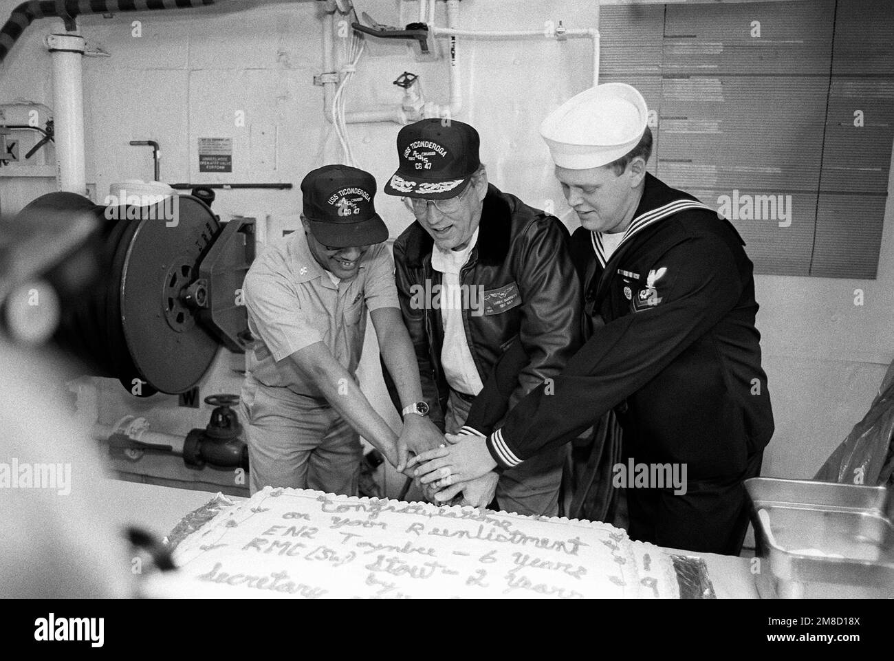 Secretary of the Navy H. Lawrence Garrett III and two crew members cut ...