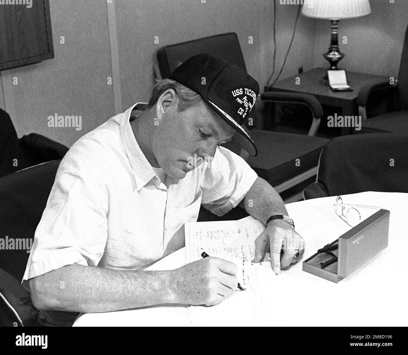 Secretary of the Navy H. Lawrence Garrett III signs the guest book ...