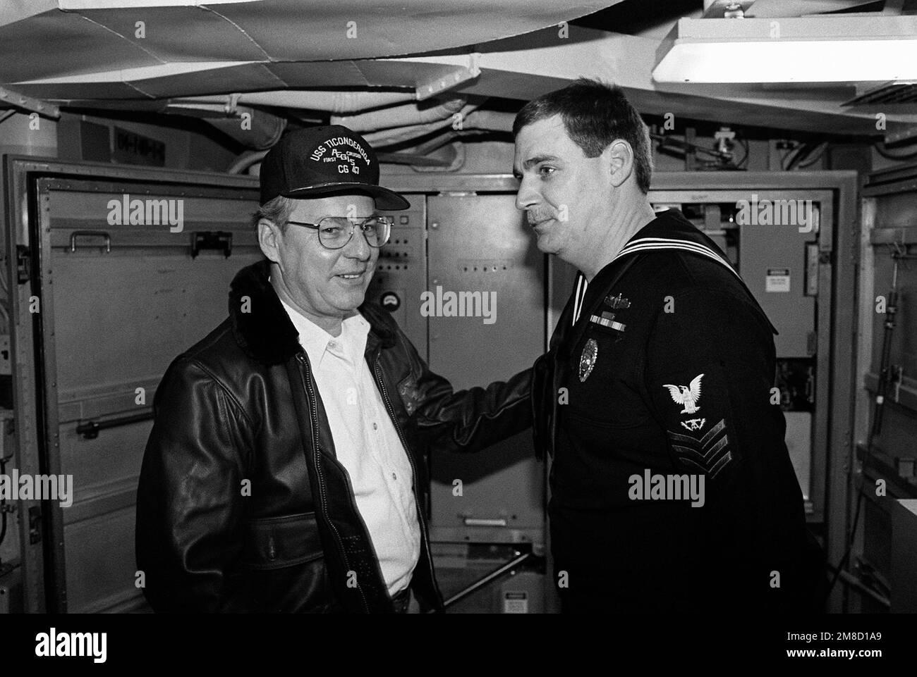Secretary of the Navy H. Lawrence Garrett III converses with a petty ...