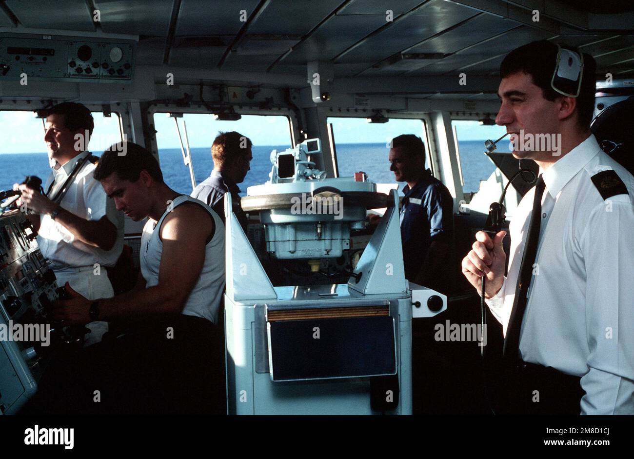 Officers and crewmen man their posts on the bridge of the British light ...