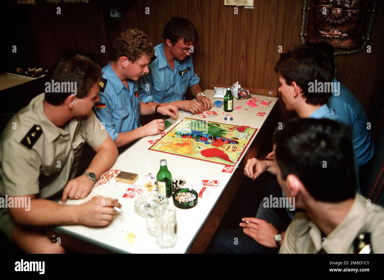 Off-duty sailors play a board game in the enlisted mess aboard the West ...