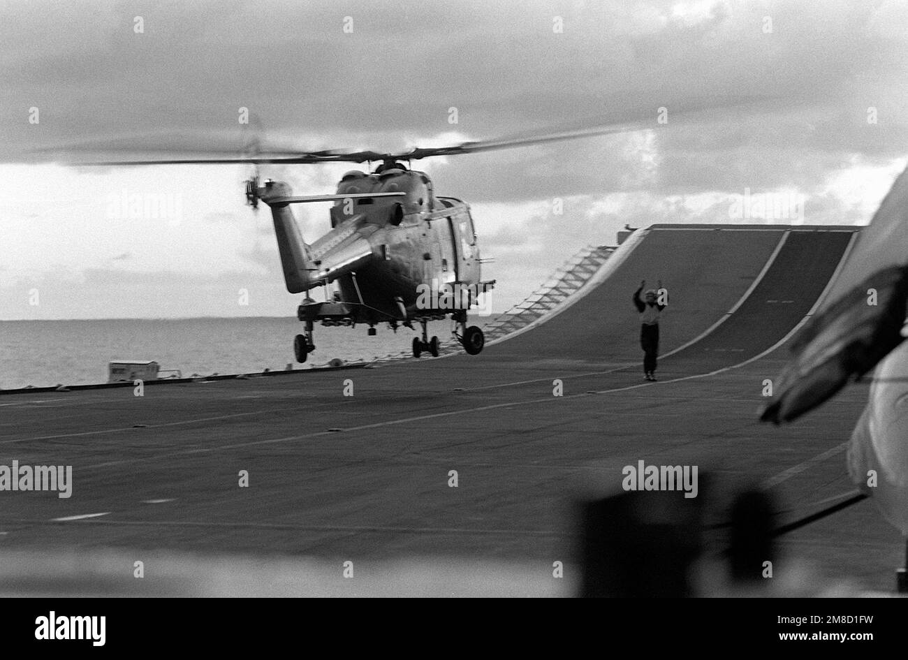 A flight deck crewman aboard the light aircraft carrier HMS INVINCIBLE ...