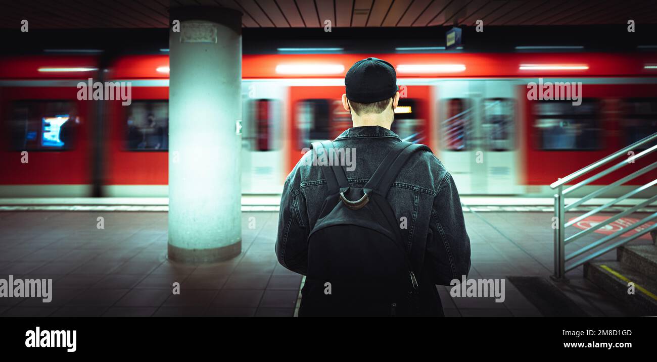 A panoramic back view of a passenger in the metro station Stock Photo ...