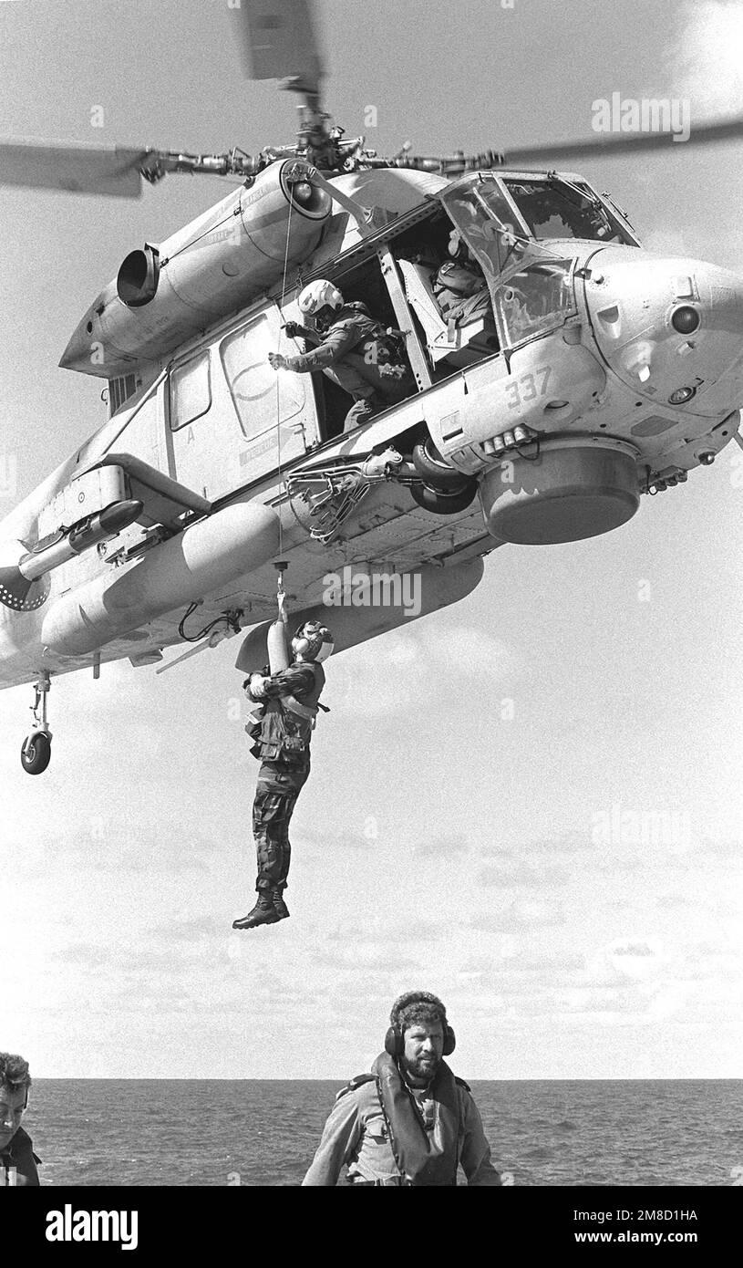 PH1 Michael Flynn is hoisted onto a Light Helicopter Anti-submarine ...
