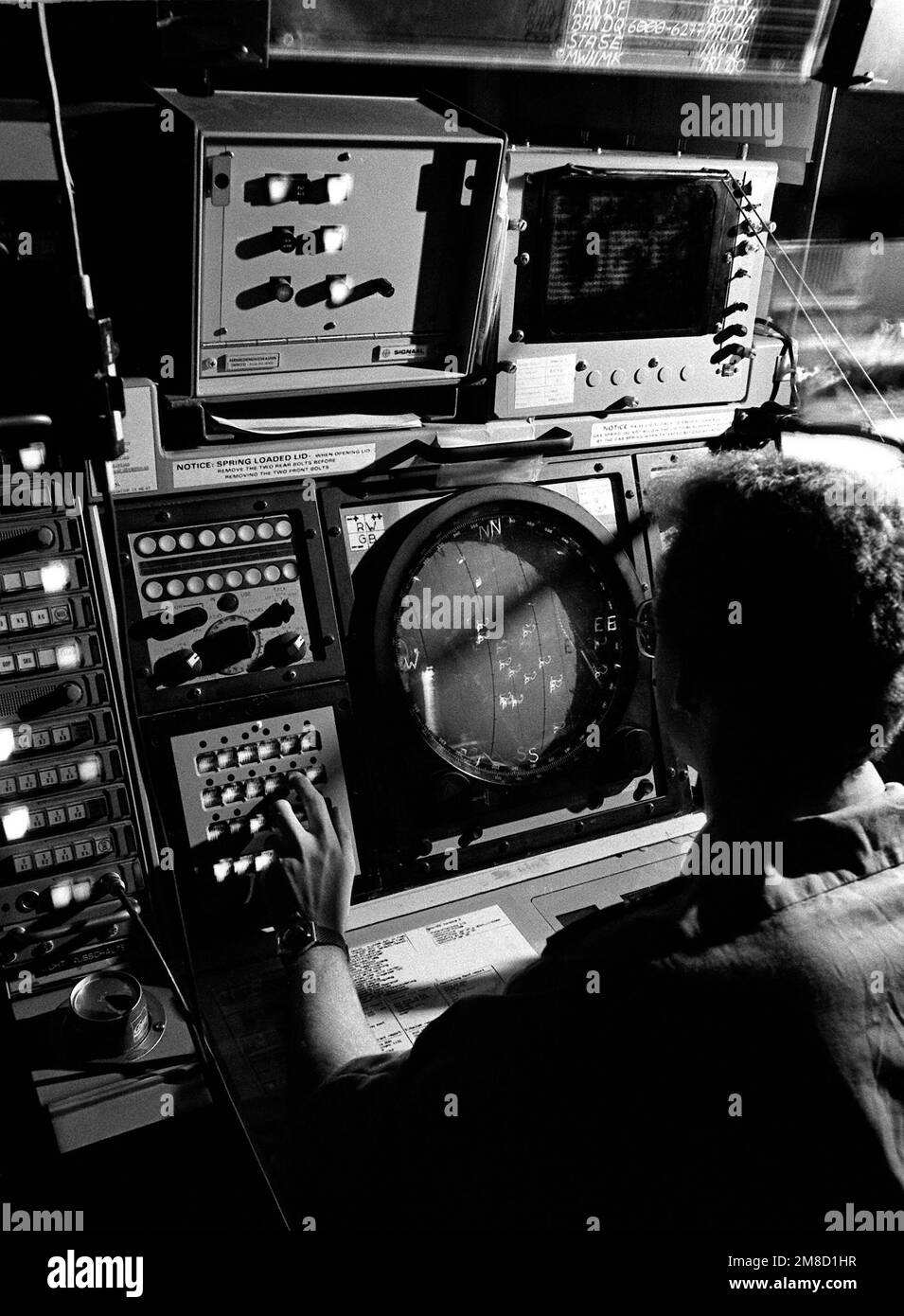 A sailor monitors a radar display in the combat information center ...
