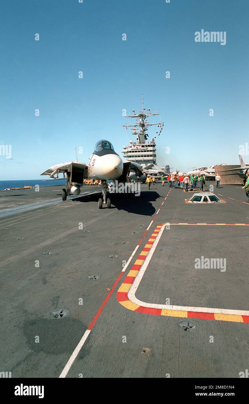 A Fighter Squadron 84 (VF-84) F-14A Tomcat aircraft waits to move into ...
