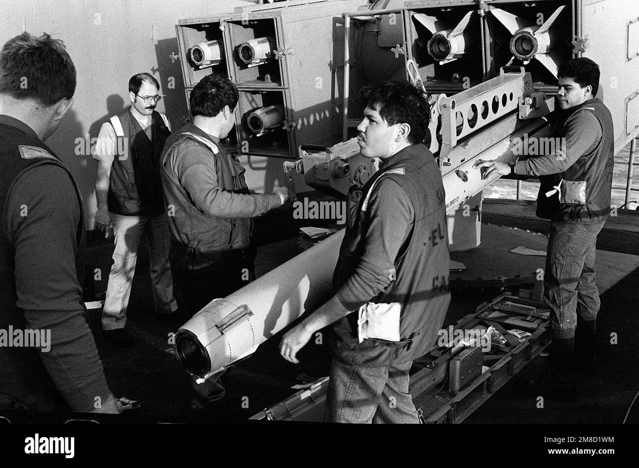 Aviation ordnancemen unload Sea Sparrow missiles from a Mark 29 ...