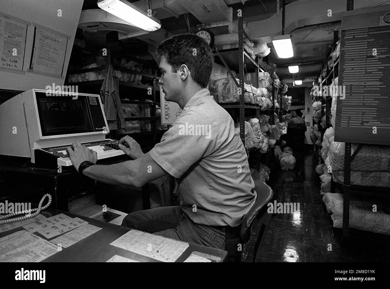 Aviation Storekeeper 3rd Class Kevin A. Jesperson uses a computer to ...
