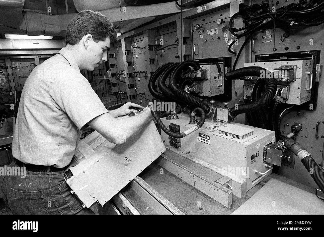 Aviation Fire Control Technician 3rd Class Charles M. Kyle uses a ...
