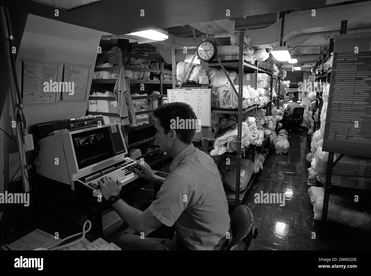 Aviation Storekeeper 3rd Class Kevin A. Jesperson uses a computer to ...