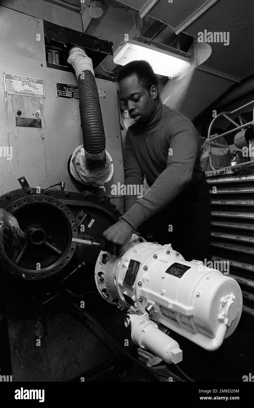 Aviation Electrician's Mate AIRMAN Vincent Roberts tightens a generator ...