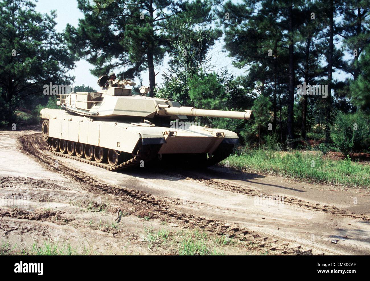Soldiers operate a desert camouflaged M-1 Abrams tank during advanced ...