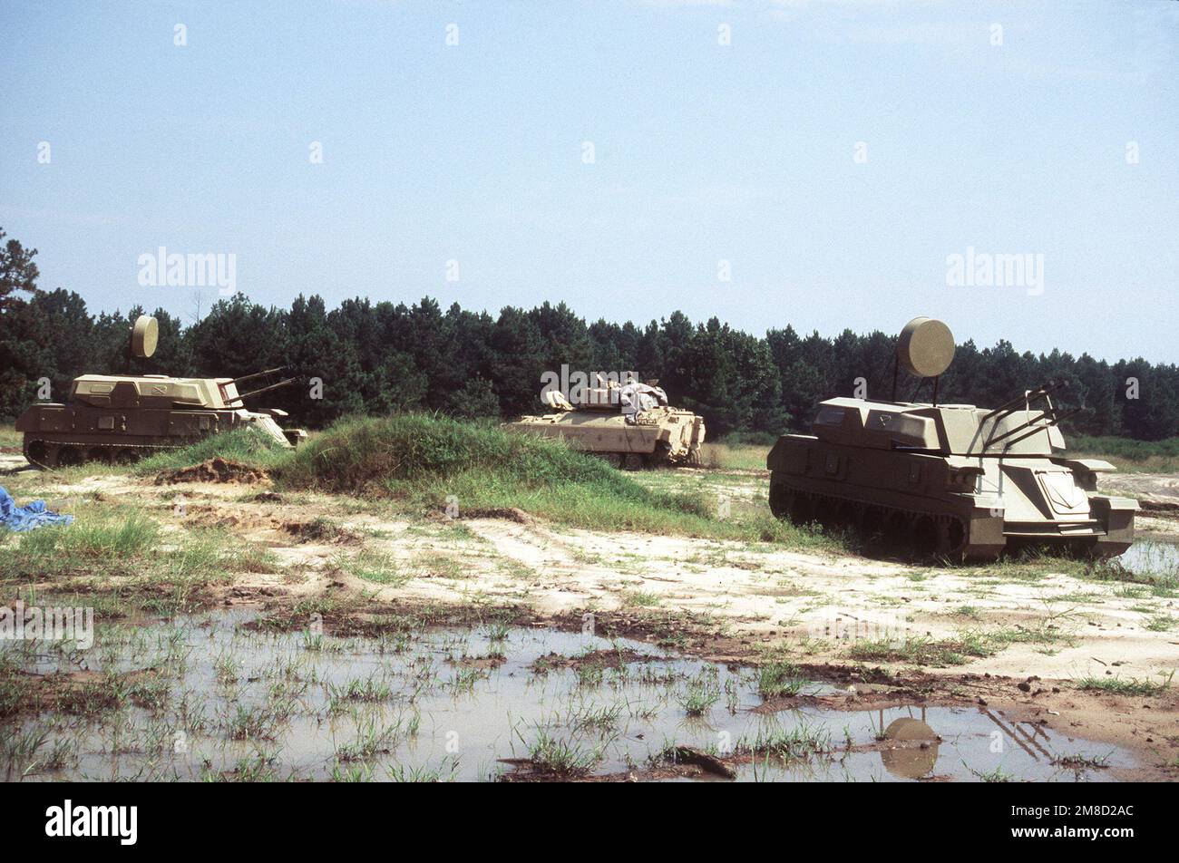 Soldiers operating a desert camouflaged M-2 Bradley infantry fighting ...
