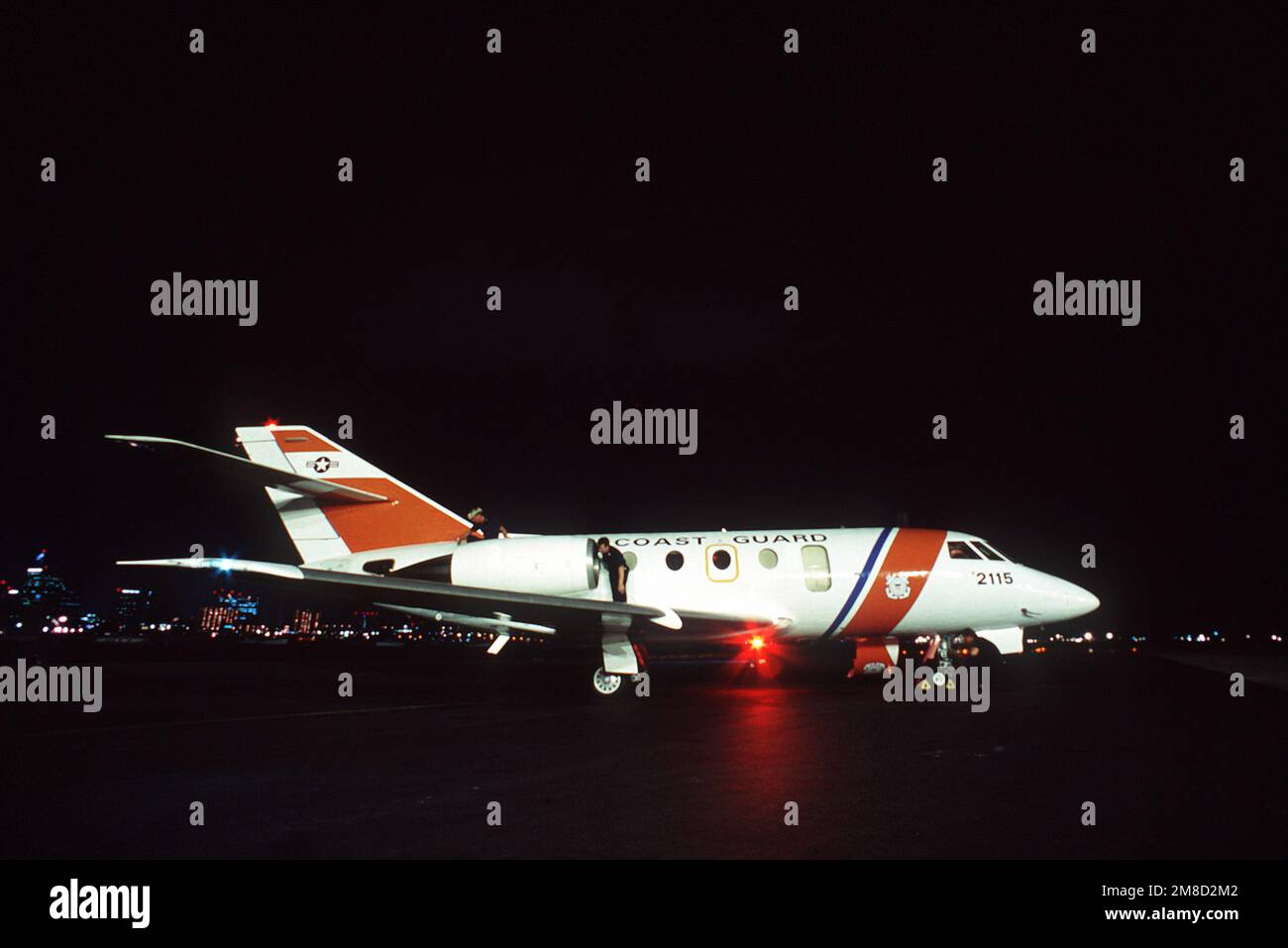 Ground crew members conduct a preflight check on a U.S. Coast Guard HU ...
