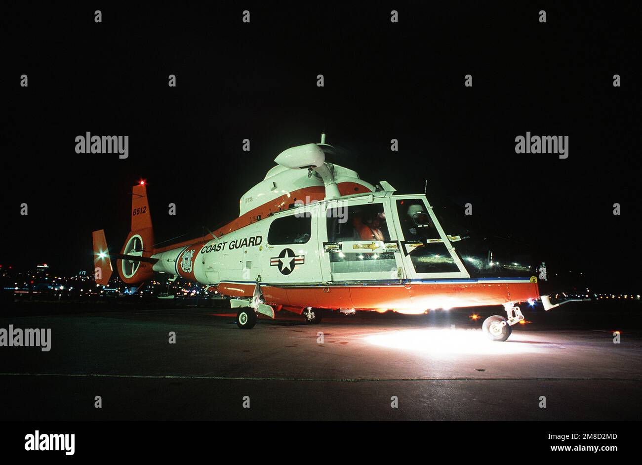 A U.S. Coast Guard HH-65A Dolphin helicopter prepares to takeoff on a ...