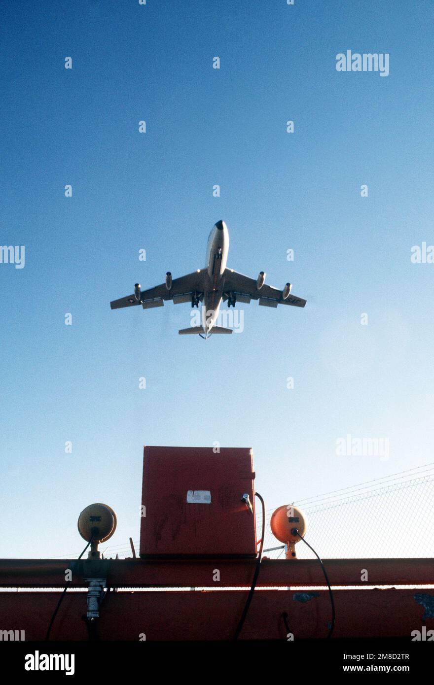 A 5th Bomb Wing KC-135 Stratotanker aircraft flies over a fence at the edge of the base while on ...