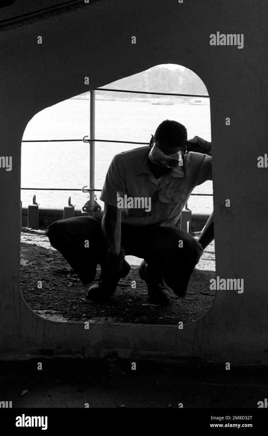 A sailor aboard the dock landing ship USS FORT FISHER (LSD-40) breaks ...