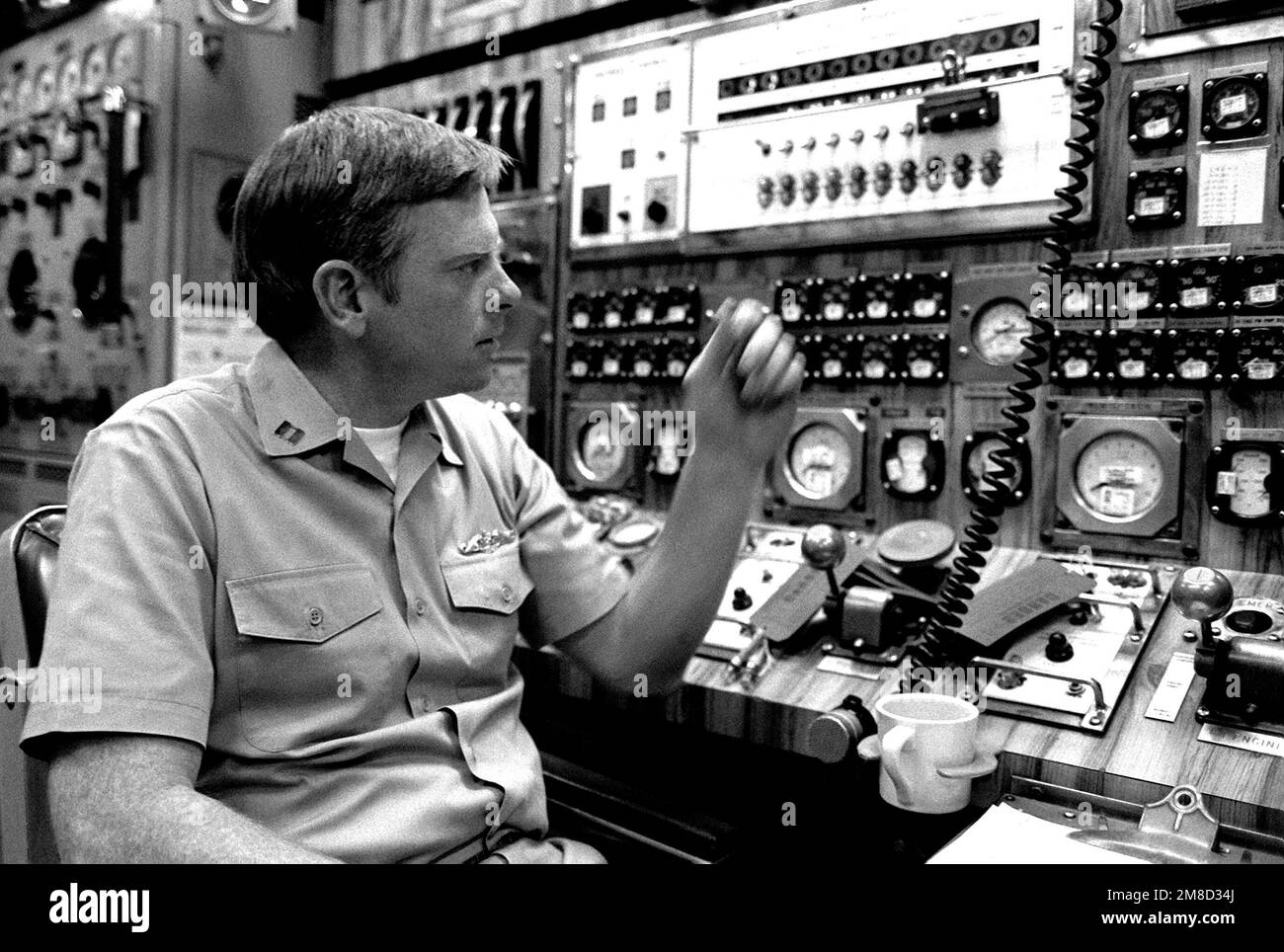 A lieutenant sits at an engine control panel aboard the attack ...