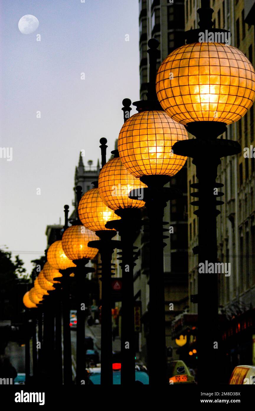 Old fashioned street lights lined up in a row as dusk turns into ...