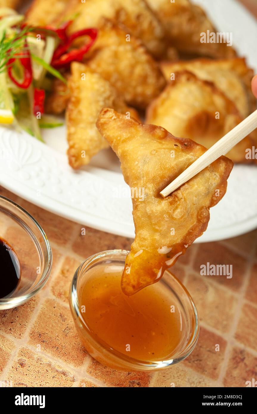 Chinese wontons with sweet chilli dip sauce and chop sticks Asian fried ...