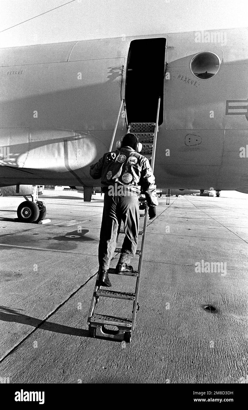 A member of Naval Air Reserve Patrol Squadron 66 (VP-66) boards a P-3 ...
