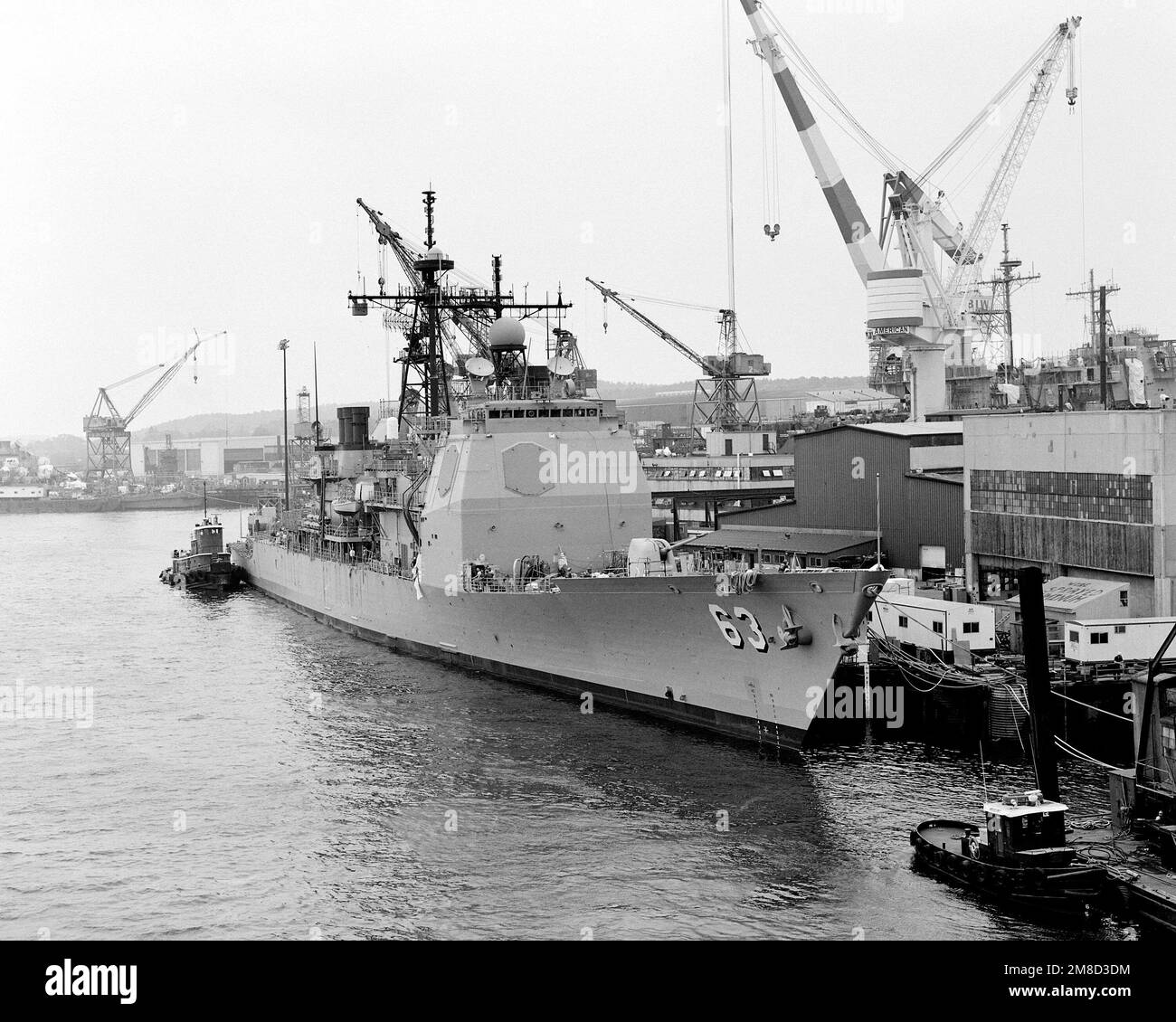 A starboard bow view of the guided missile cruiser COWPENS (CG-63) tied ...