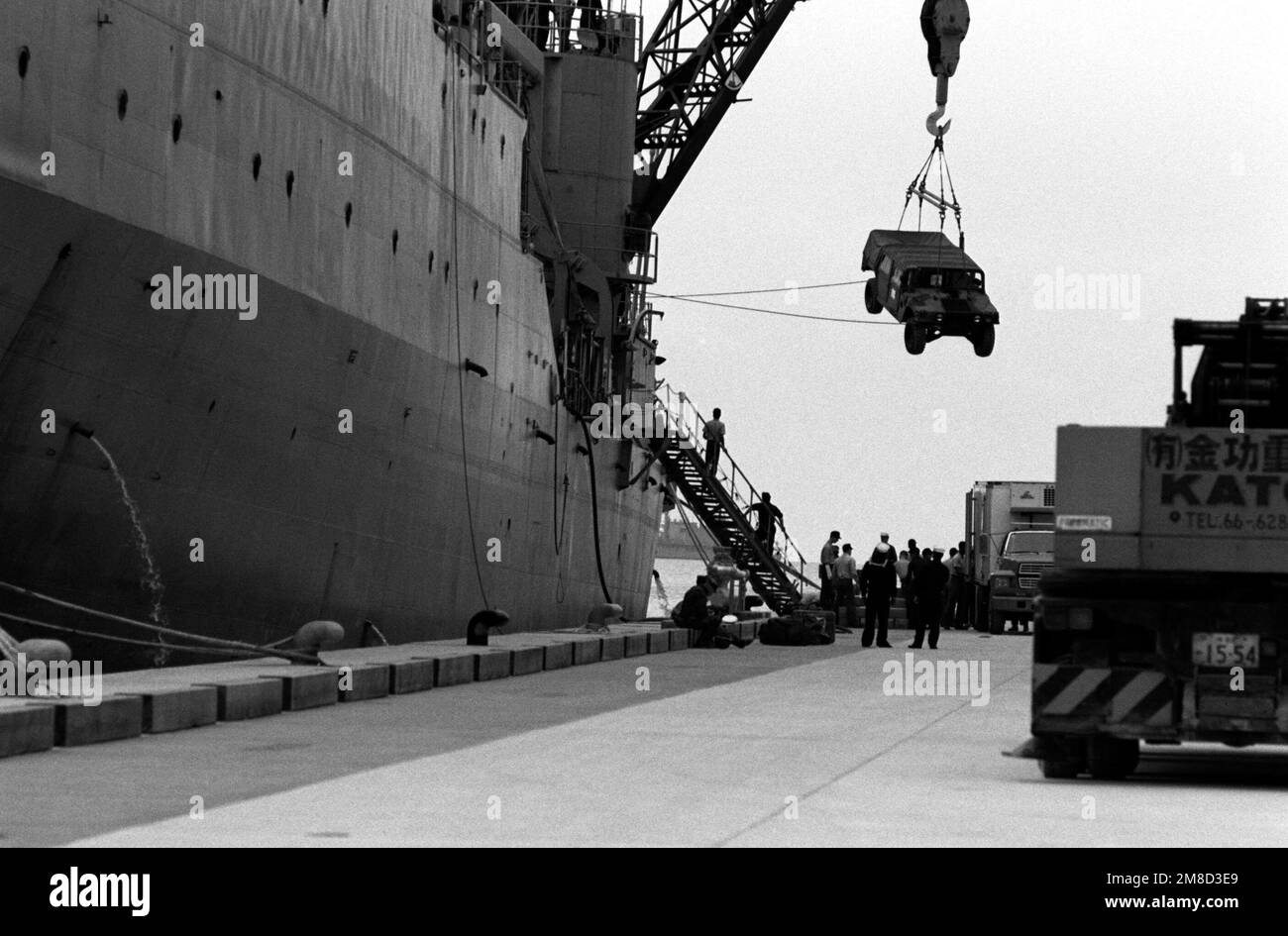 An M998 High-Mobility Multipurpose Wheeled Vehicle (HMMWV) is hoisted ...