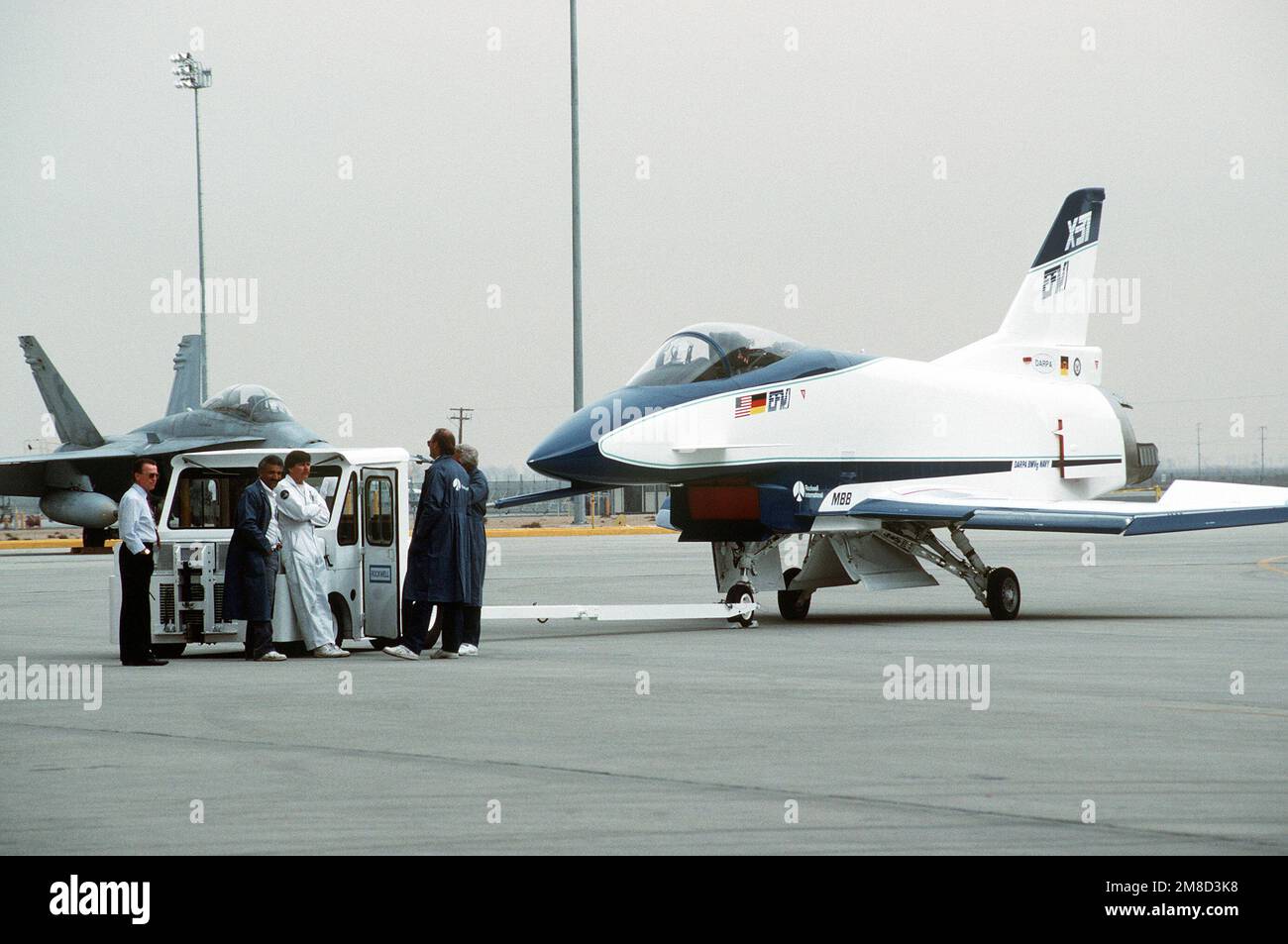 Rockwell International Corporation employees stand by the X-31 Enhanced ...