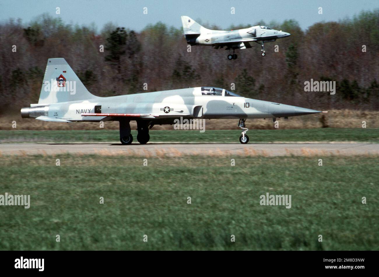 A Fighter Squadron 43 (VF-43) F-5E Tiger II aircraft rolls along a ...